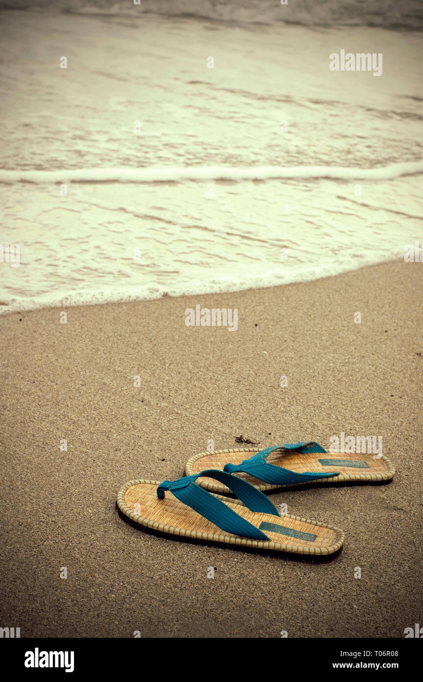 Sepia Colored Blue Sandals on a Tropical Beach Stock Photo - Alamy