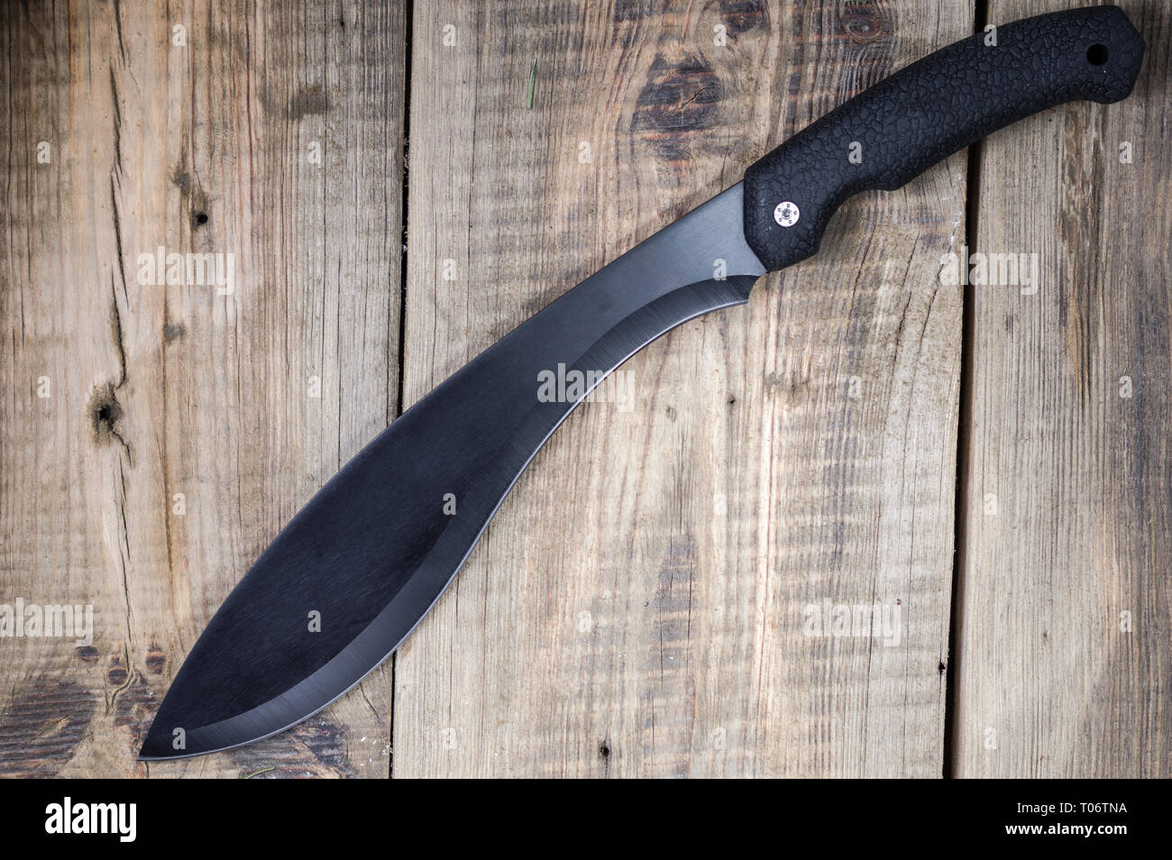 Black machete on wooden background. Machete top view Stock Photo - Alamy