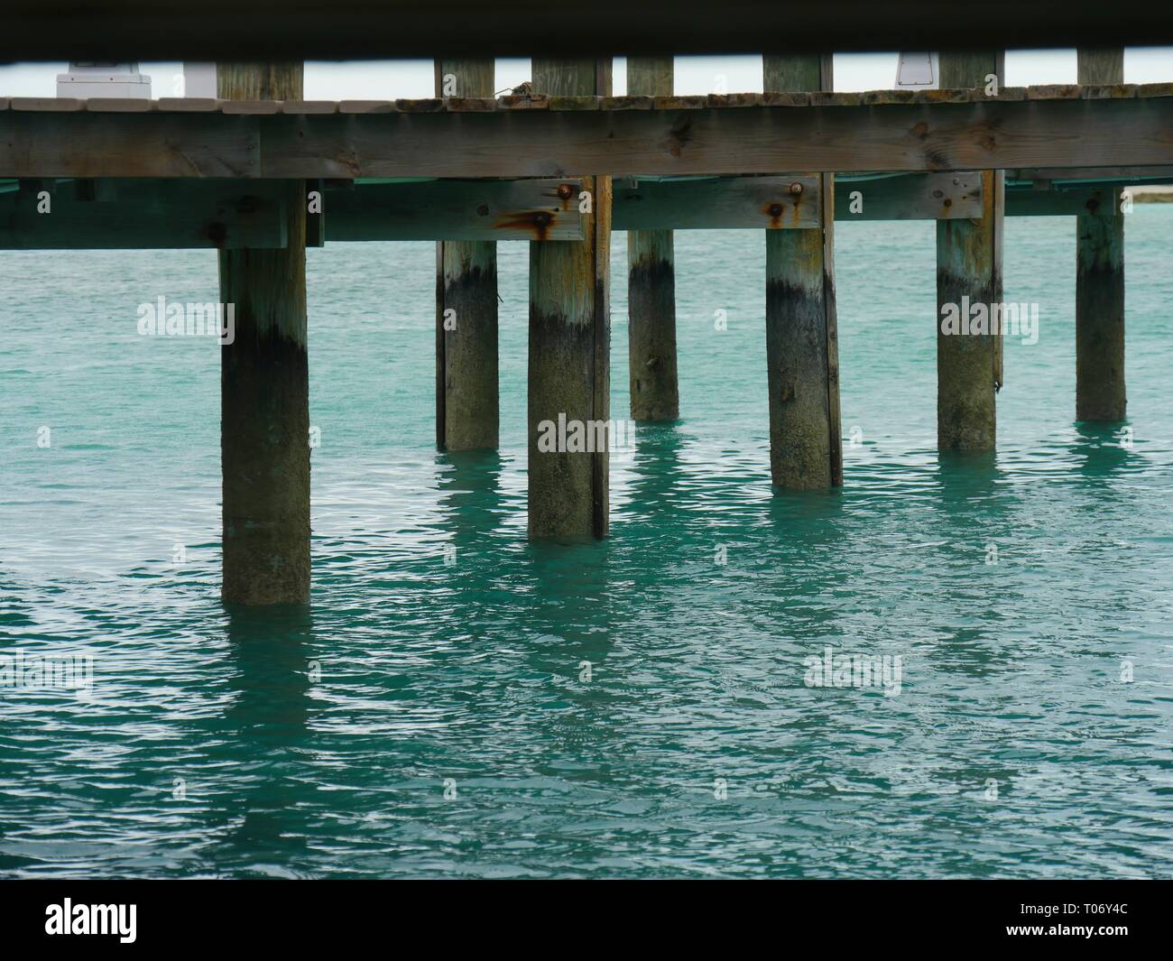 Wooden planks support a platform serving as a dock to visiting boats in ...