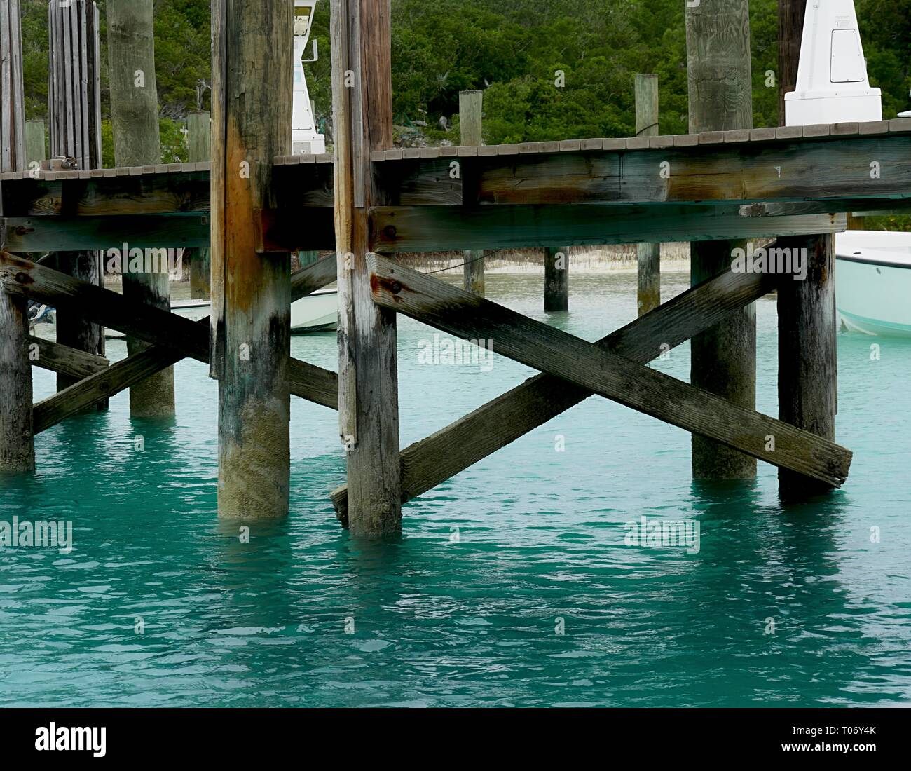 Close up of wooden posts and planks supporting a dock to visiting boats ...