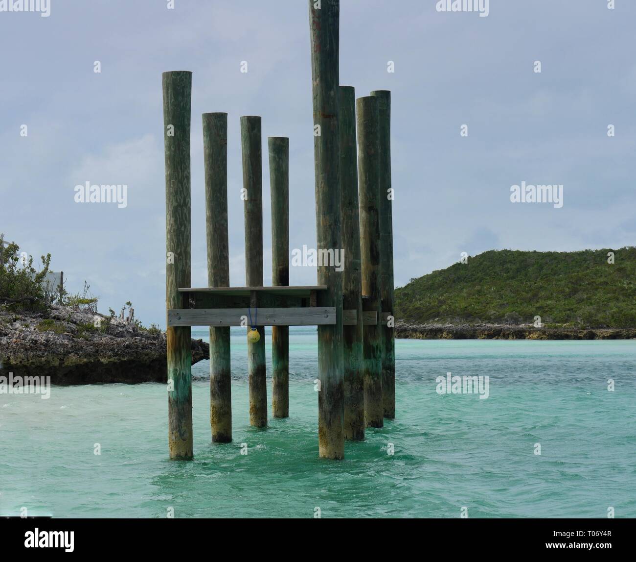 Wooden posts supporting a dock to visiting boats in one of the islands ...