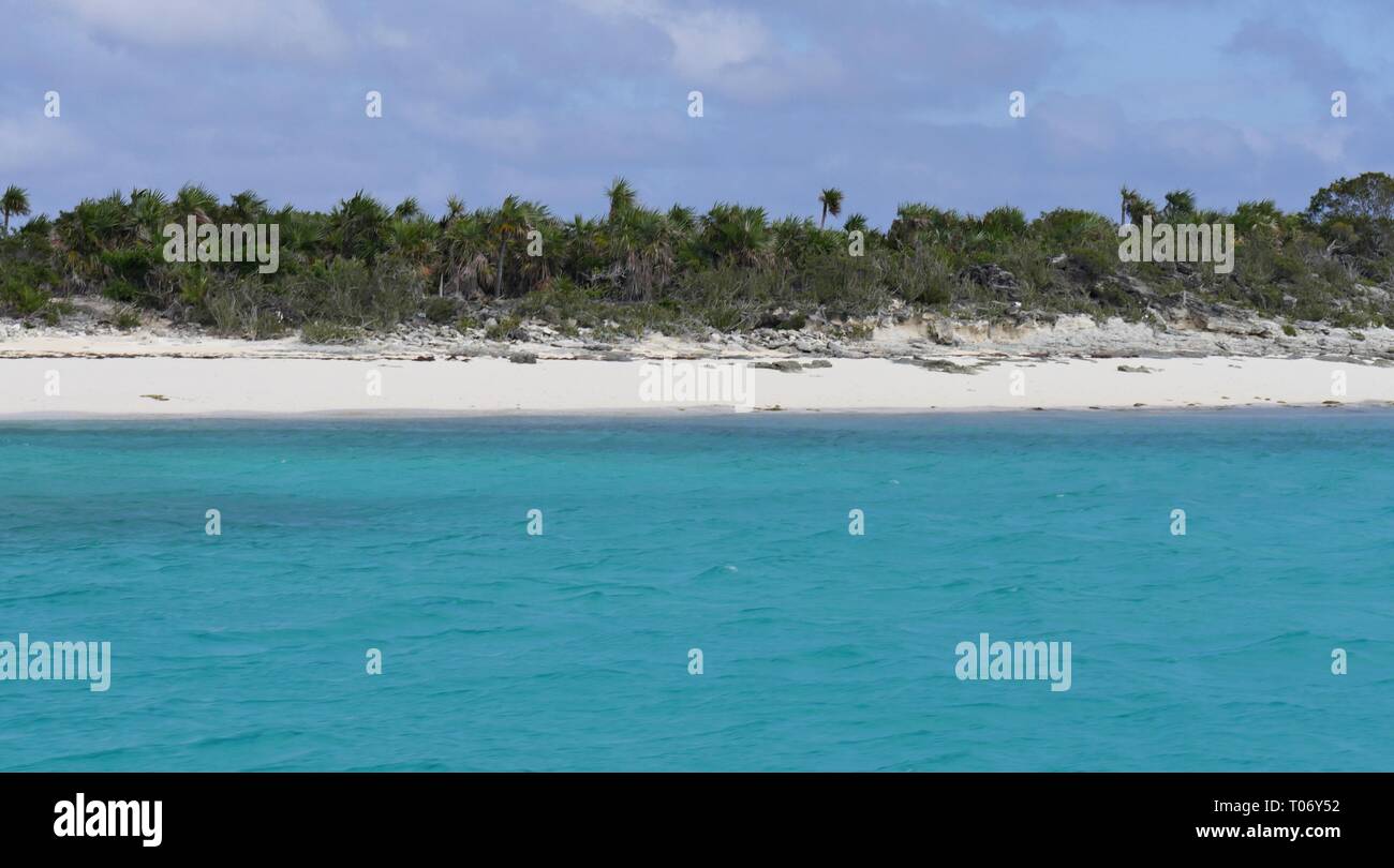 A stunningly white sandy beachline gives perfect contrast to the blue ...