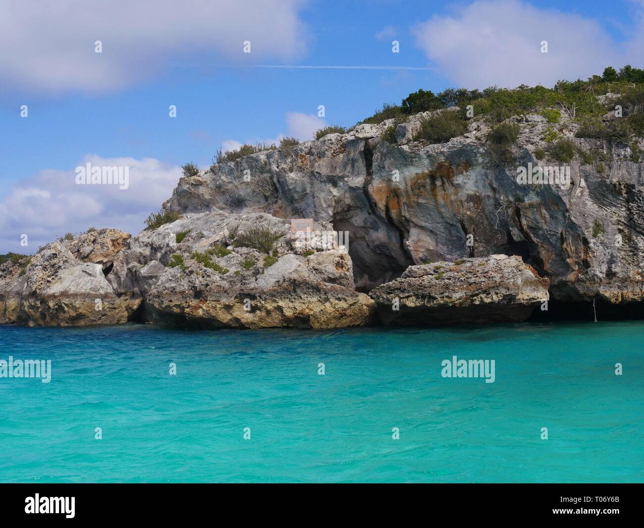 Rocky island at the Thunderball Grotto in the blue waters of Exuma Cays ...