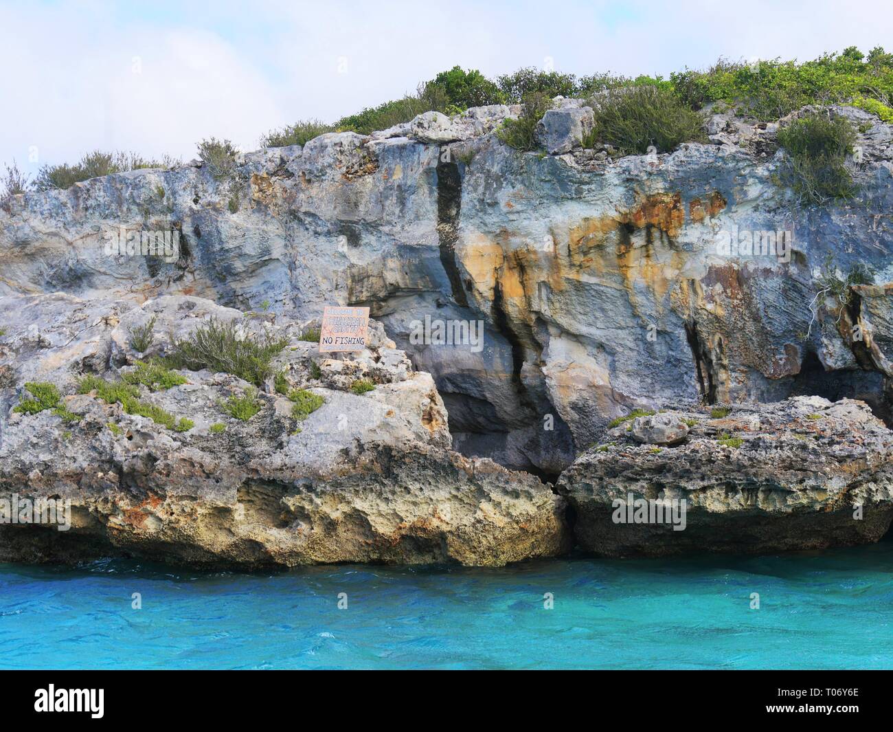 Close up of the rocky cliffs at the Thunderball Grotto in the blue ...
