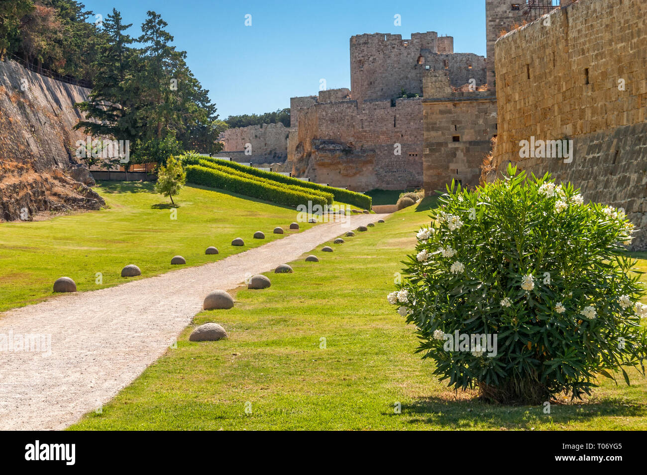 Footpath between old town massive walls in Rhodes Stock Photo - Alamy