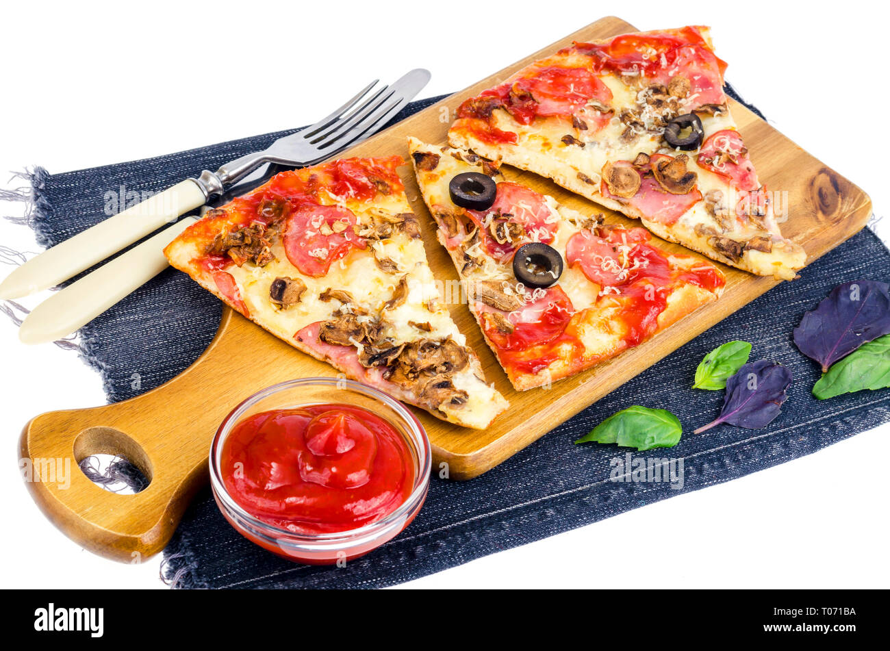 Slices of pizza on wooden board on jeans. Studio Photo Stock Photo - Alamy