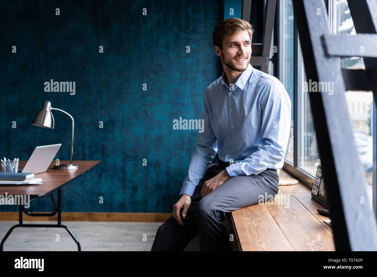 Confident businessman stands desk hi-res stock photography and images ...