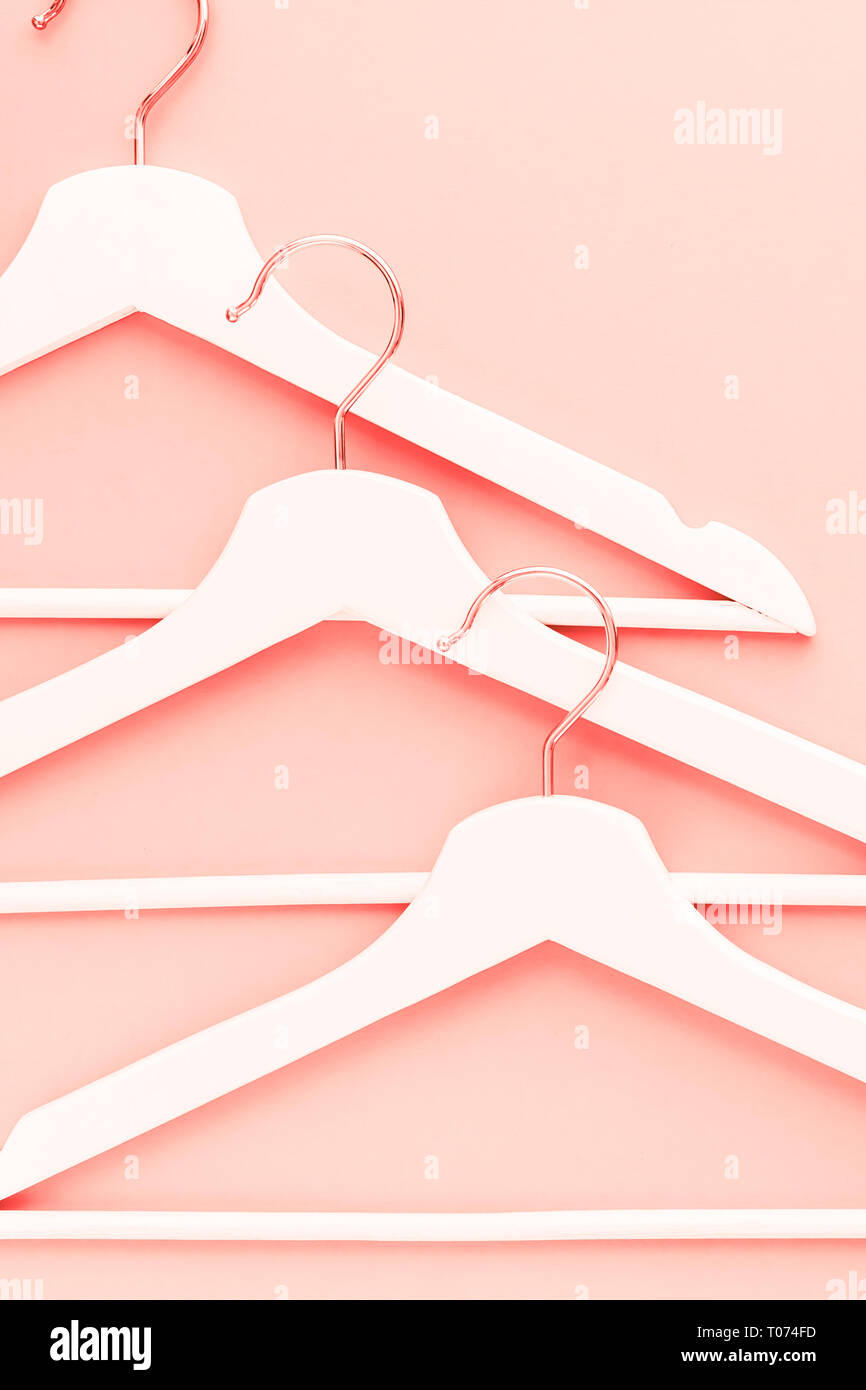 Creative top view flat lay wooden hangers toned living coral color of ...