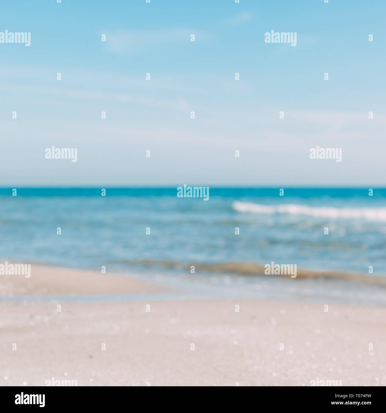 Summer sand beach and seashore waves background. Defocused blurred ...