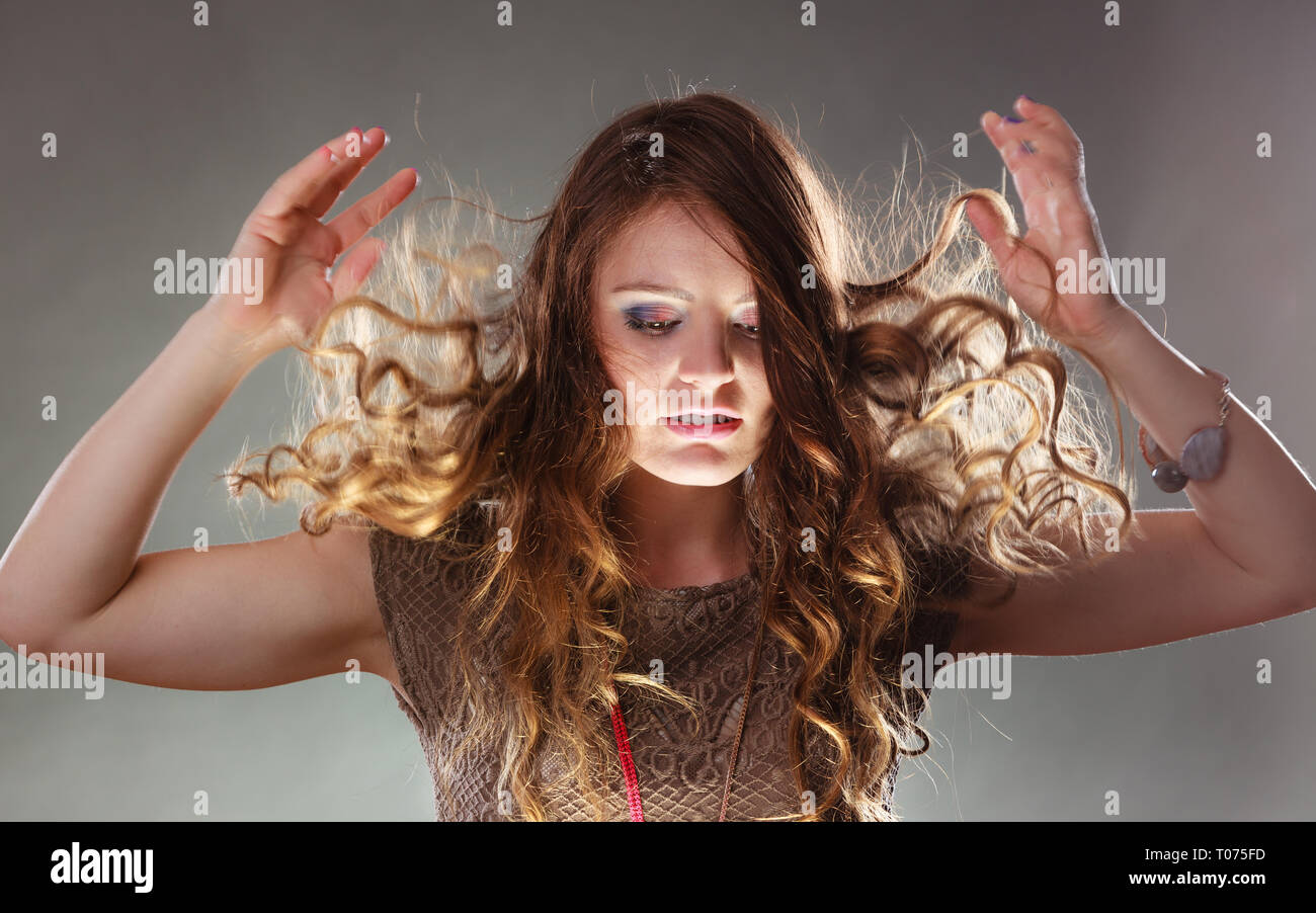 Portrait of mysterious enigmatic woman in studio on grey. Young ...