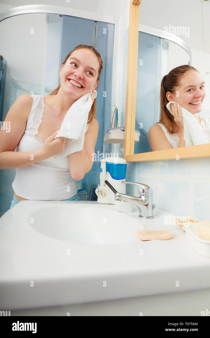 Morning hygiene. Woman cleaning washing her face with clean water in ...