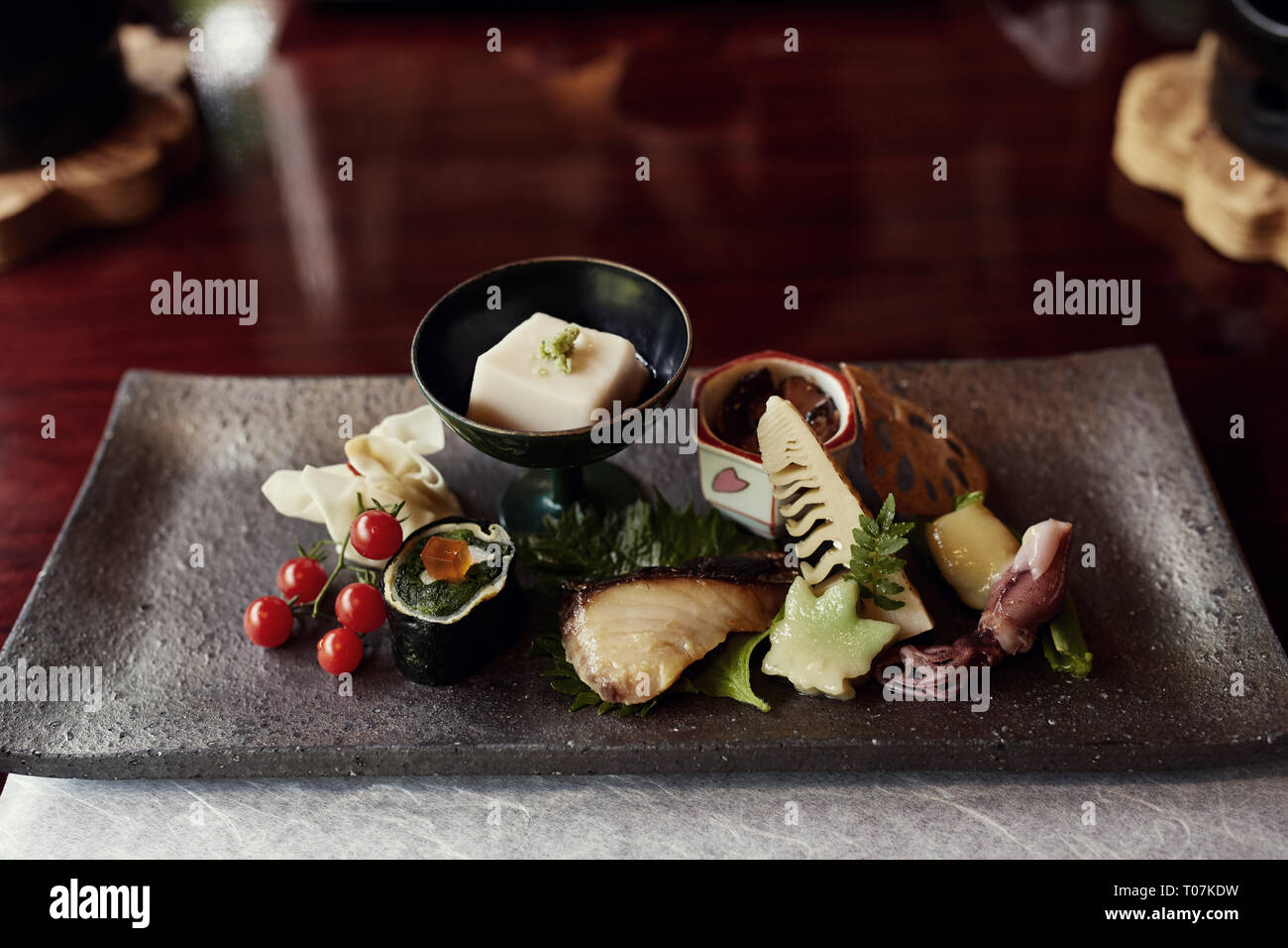 Traditional Kaiseki dinner course of tofu, vegetables and seafood ...