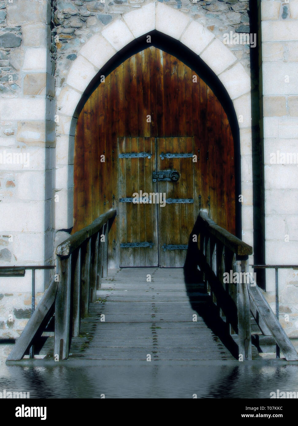 an old kings castle entrance wooden door with bridge in front Stock ...