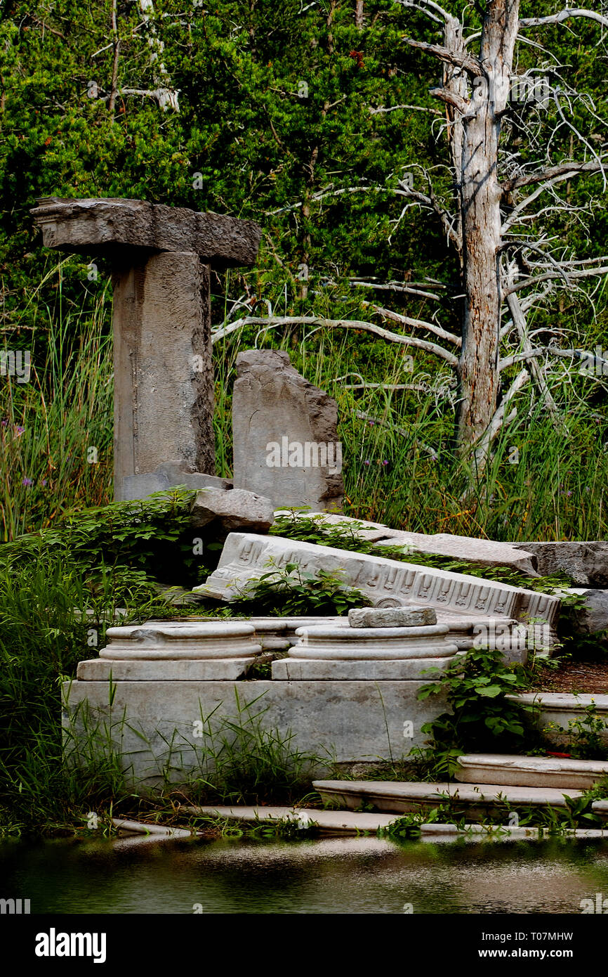 scary dark place of a graveyard with stone structures and green grass ...