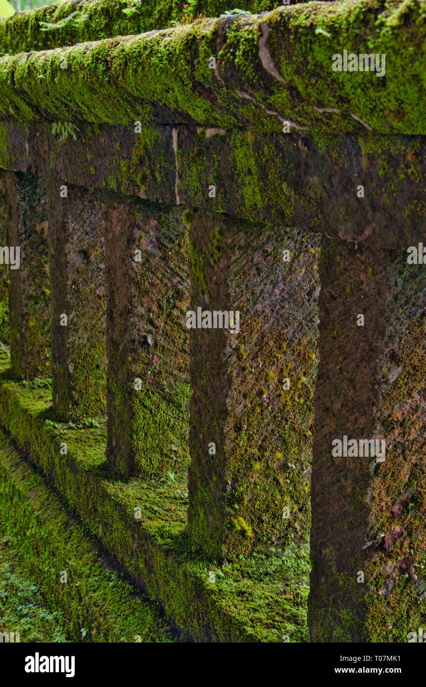 Mossy stone railing in Bali Stock Photo - Alamy