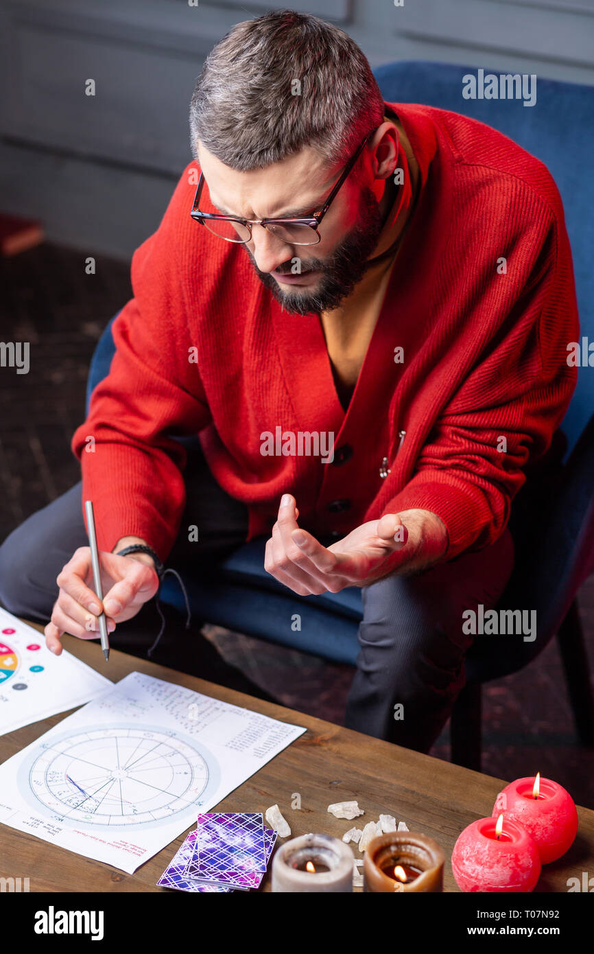 Top view of fortune-teller studying astrology and reading oracle cards ...