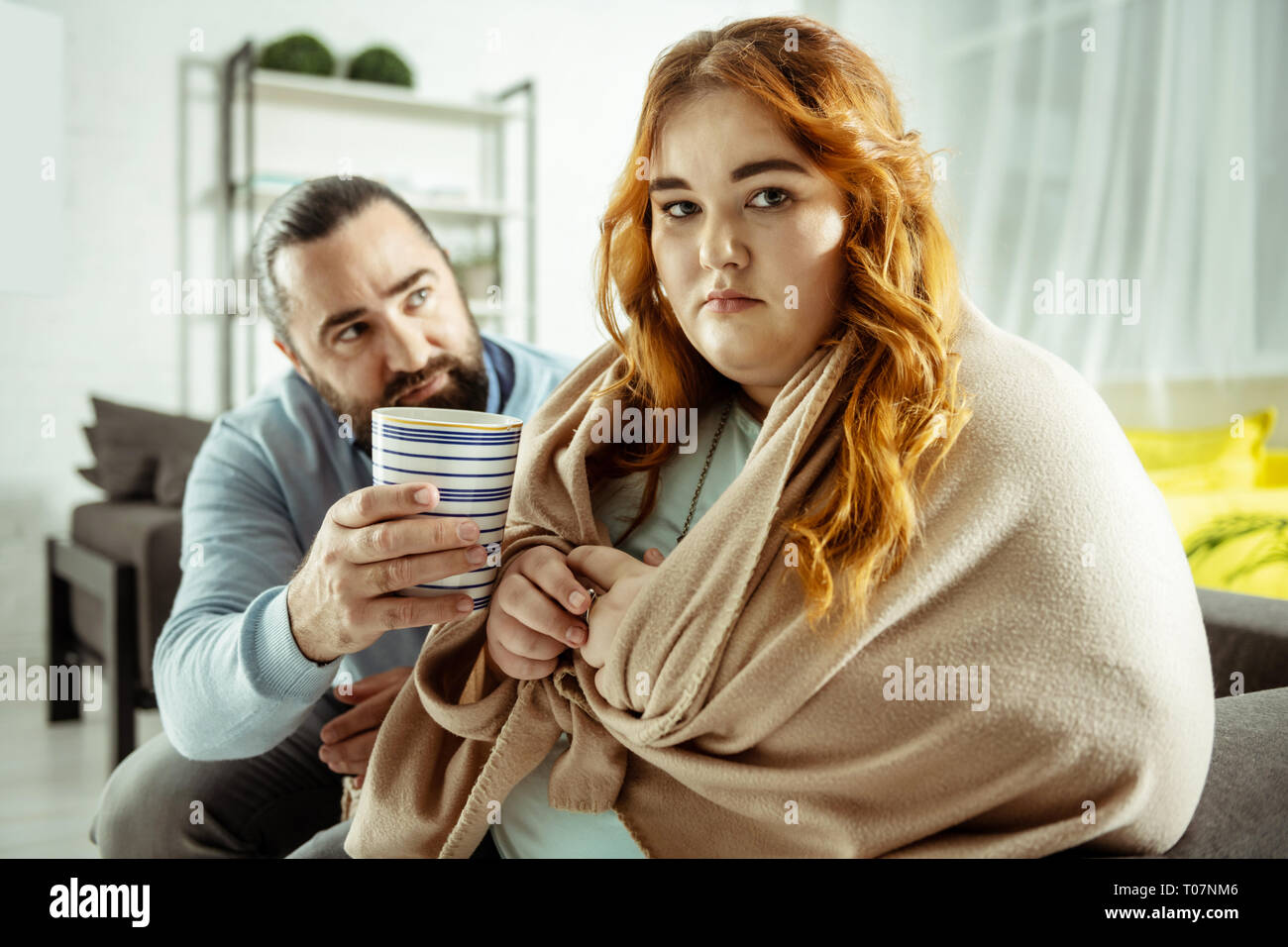 Serious red-haired female person looking at camera Stock Photo - Alamy