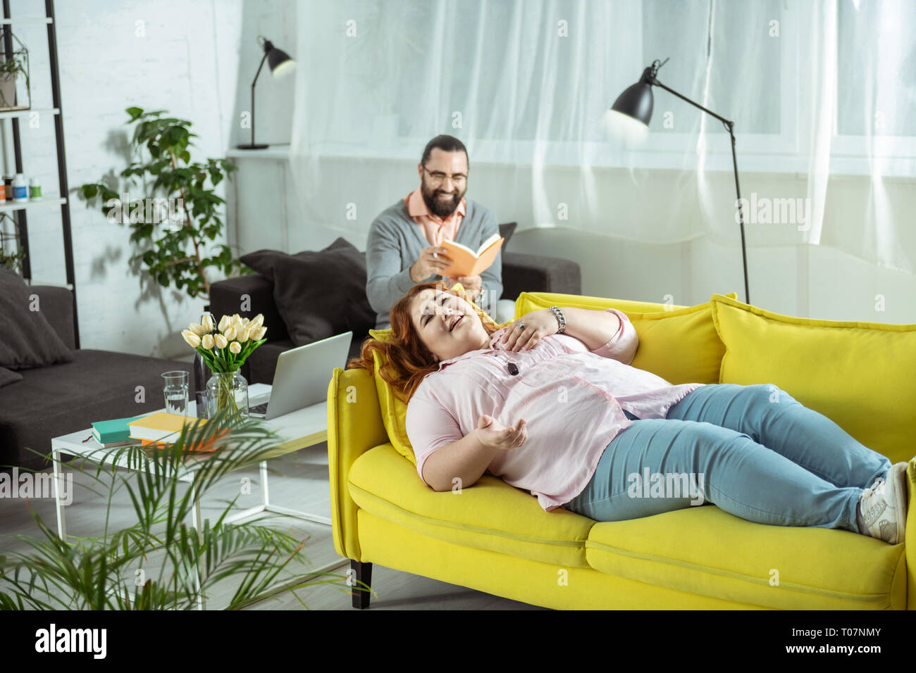 Positive delighted young woman spending time with pleasure Stock Photo ...