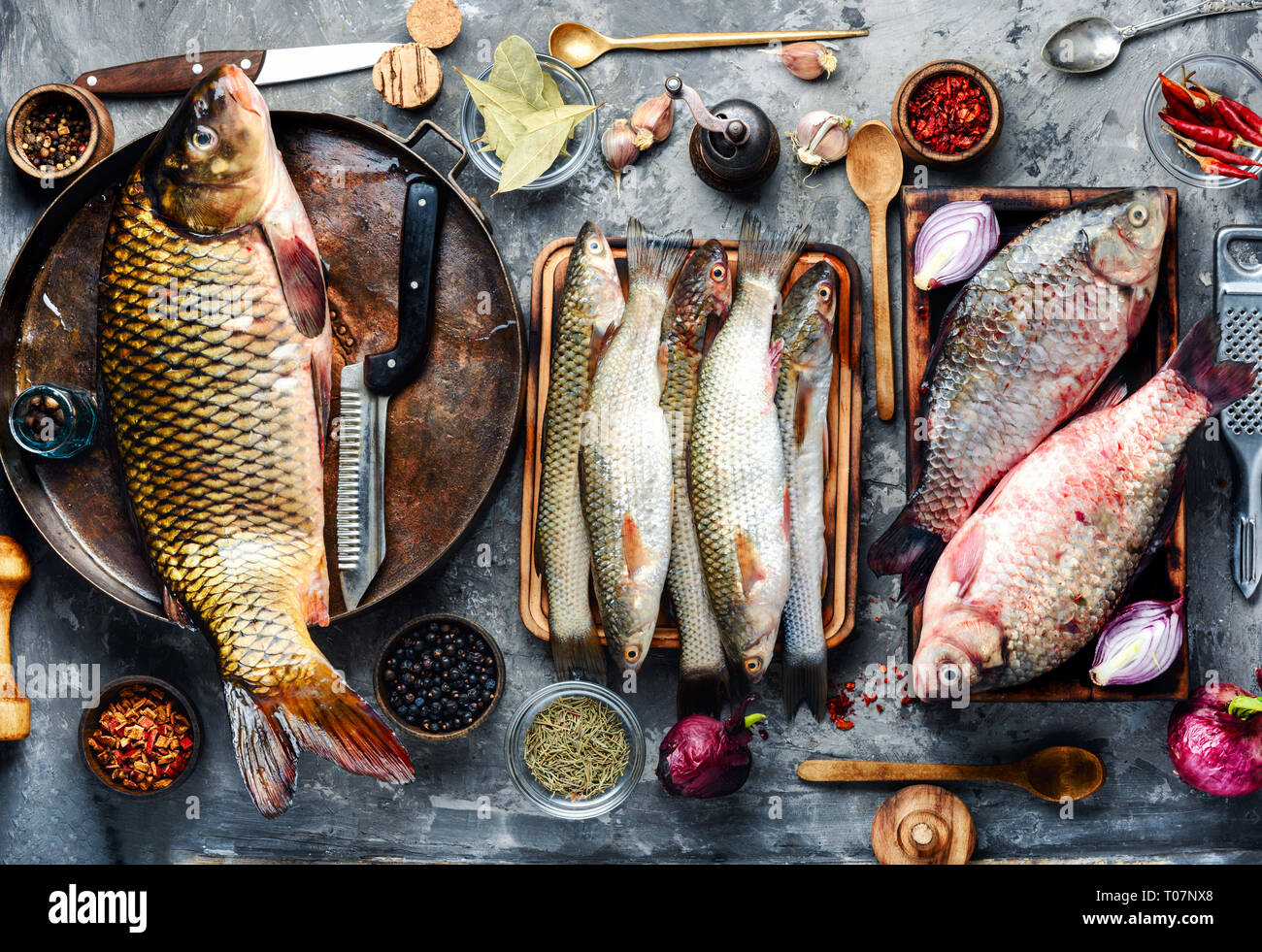 Fresh raw fish on wooden cutting board.Raw fish with spices for cooking ...