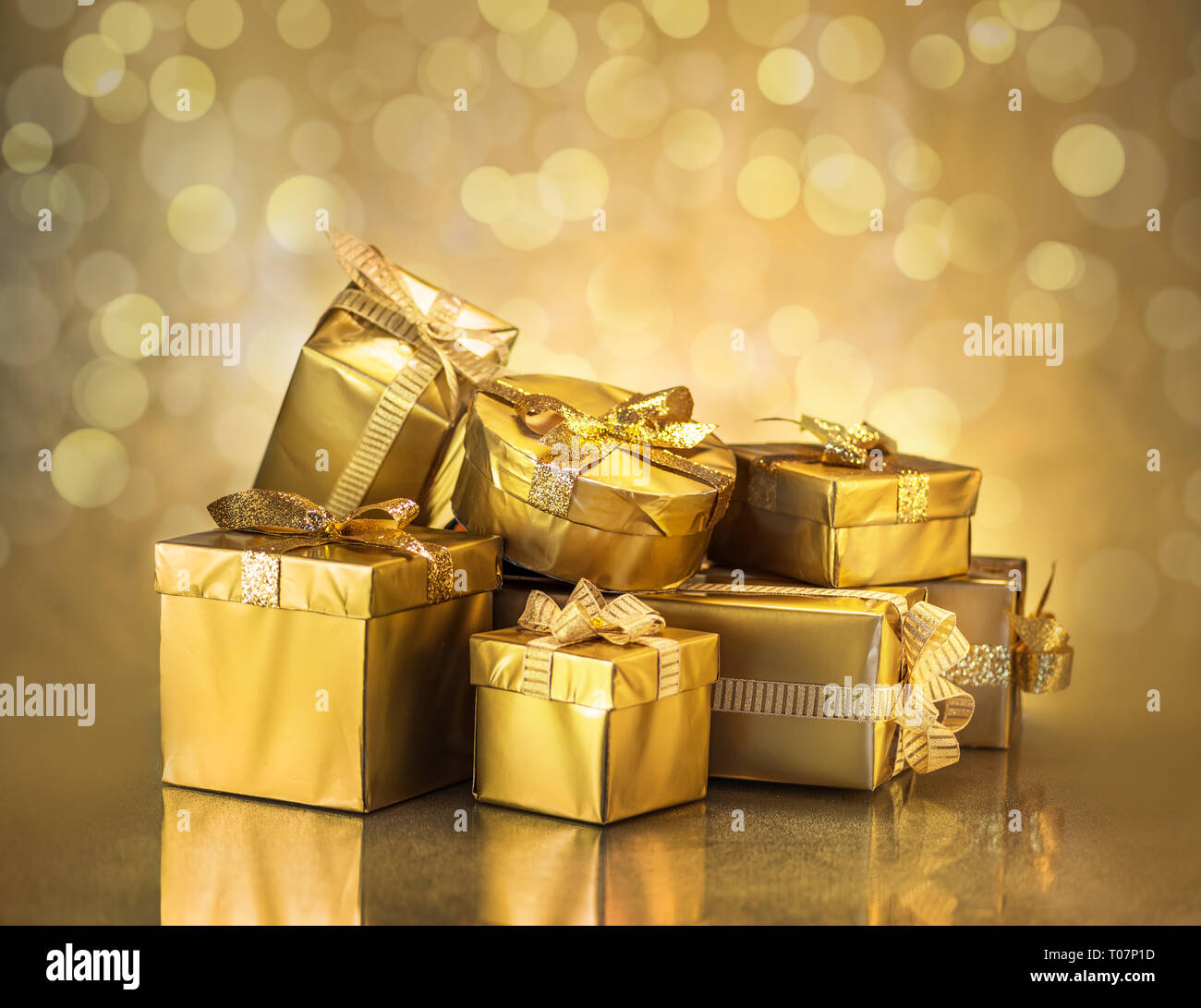 Golden gift boxes as a symbol of wishes and celebration. Golden blurred ...