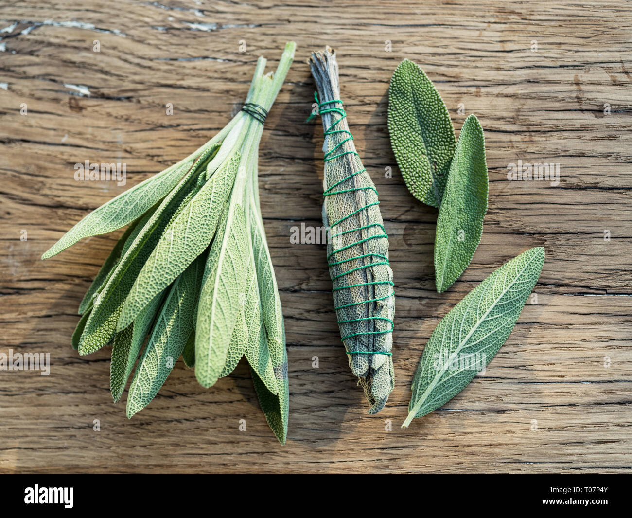 Fresh leaves of garden sage on the wooden background Stock Photo - Alamy