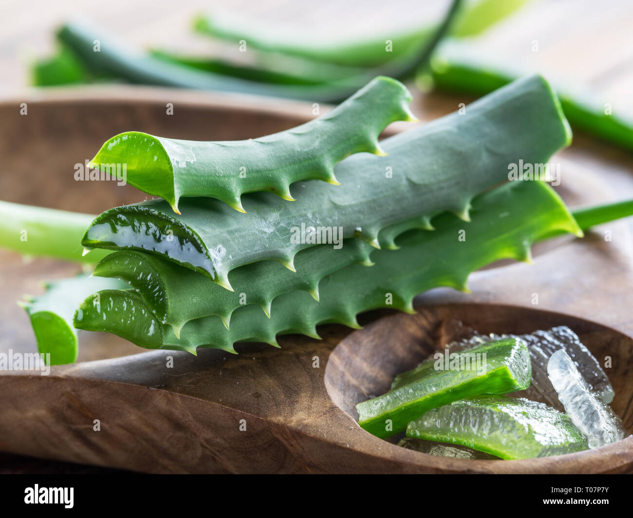 Fresh aloe leaves close up on wooden background Stock Photo - Alamy
