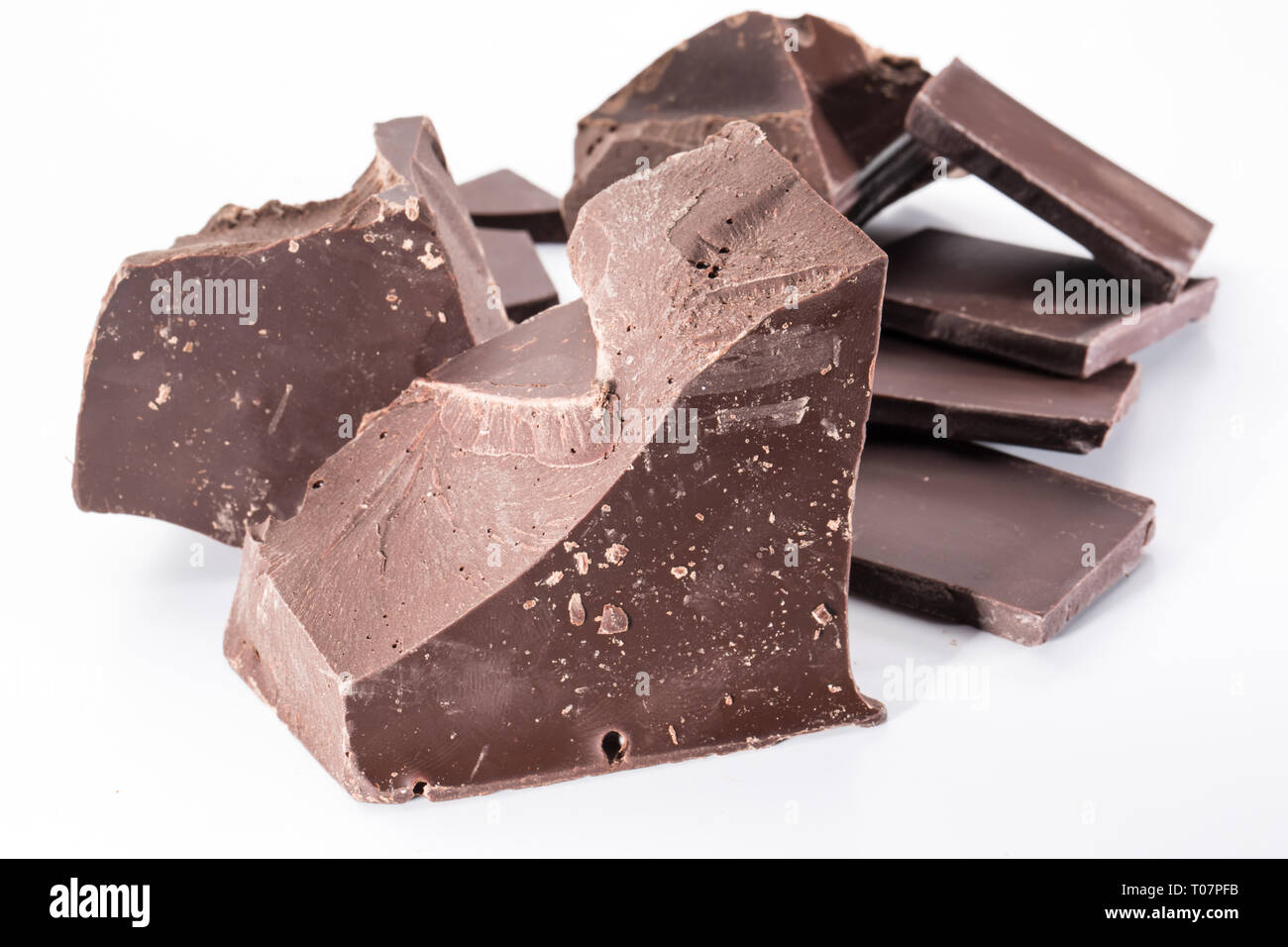 Chocolate blocks and pieces of chocolate bar isolated on a white ...