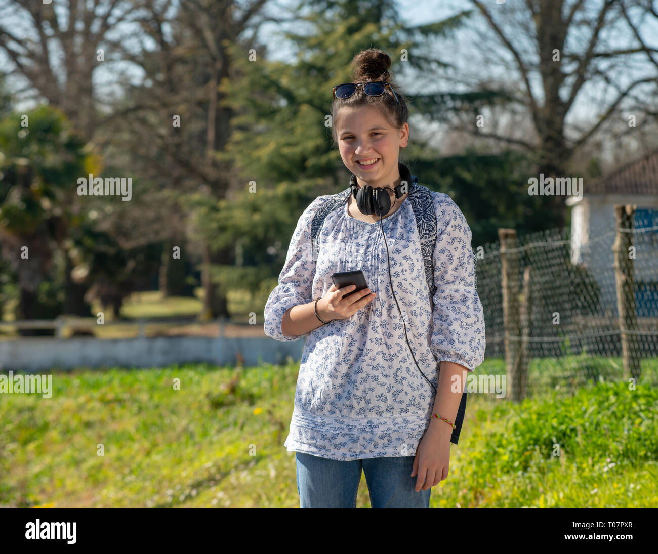 a young teenager girl waiting the school bus Stock Photo - Alamy