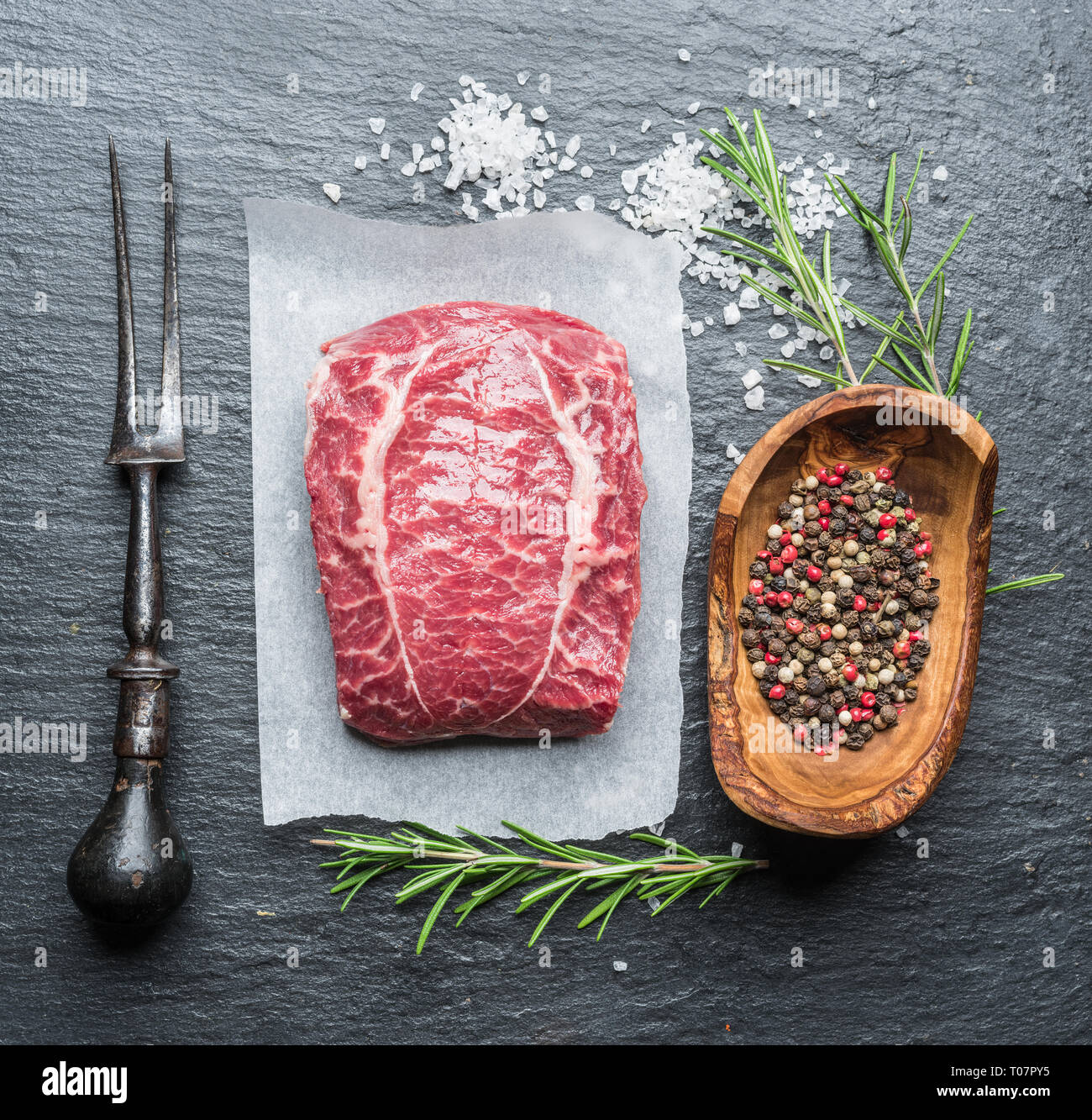 The top blade steak or beef steak on the graphite board with herbs and ...