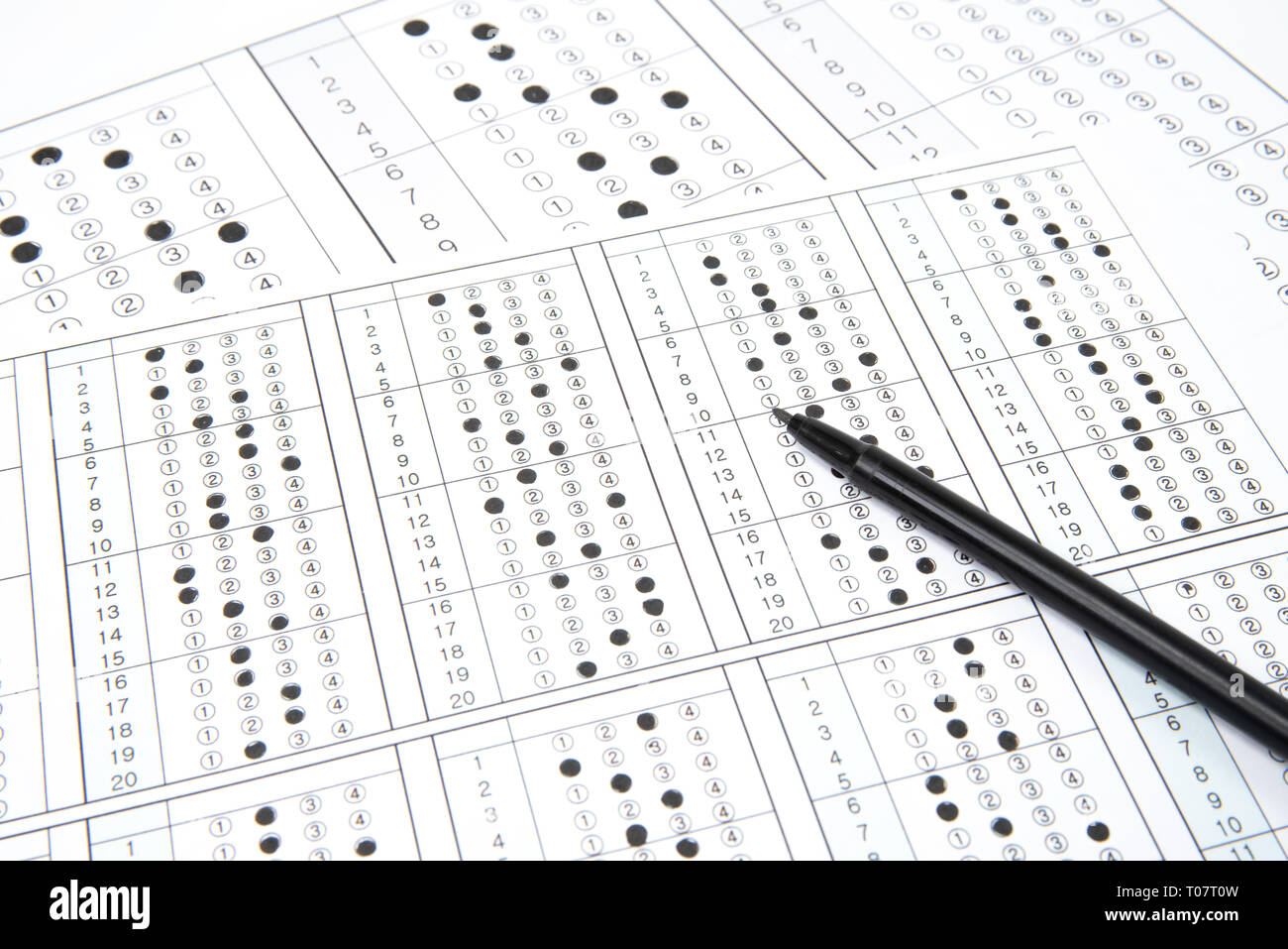 Man is filling OMR sheet handing with pen Stock Photo - Alamy