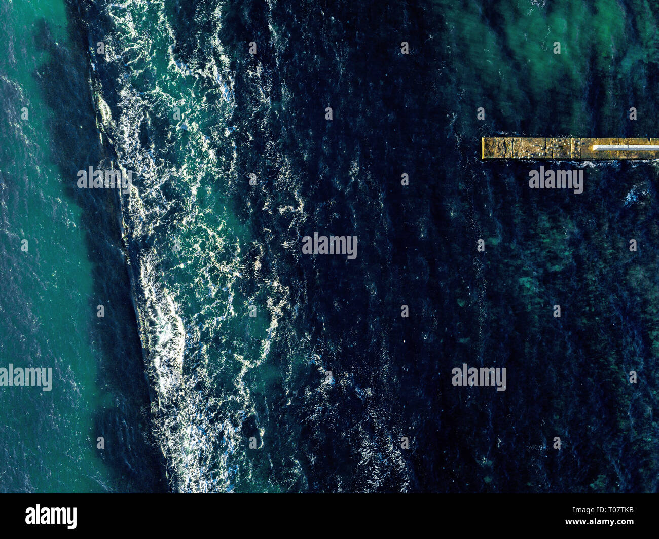 Aerial view from drone to a seascape of turquoise color water and stone ...