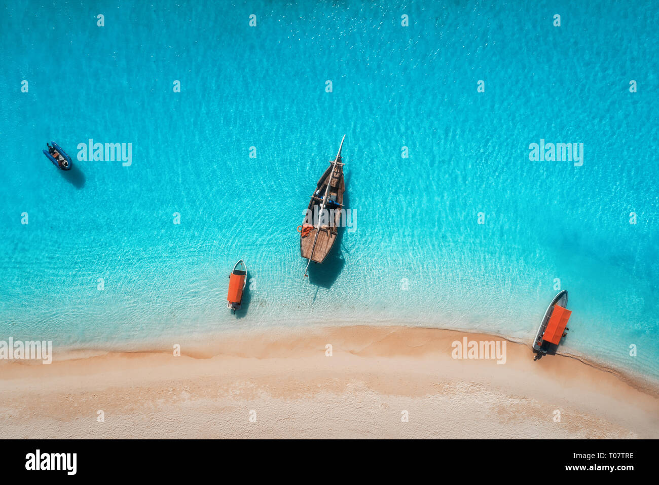 Aerial view of the fishing boats in clear blue water at sunny day in ...