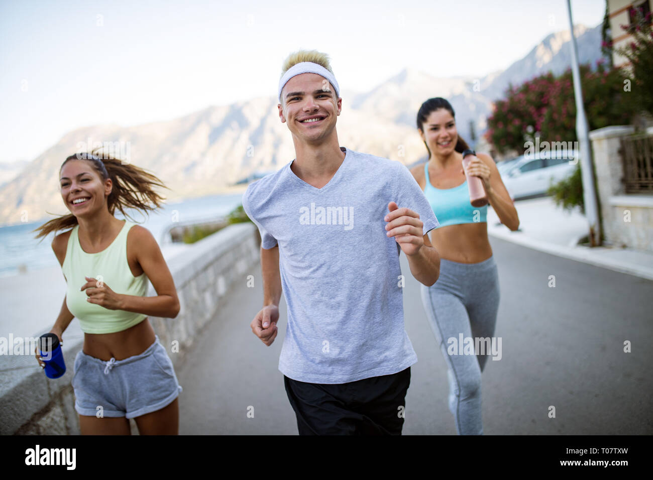 Outdoor portrait of group of friends running and jogging in nature ...
