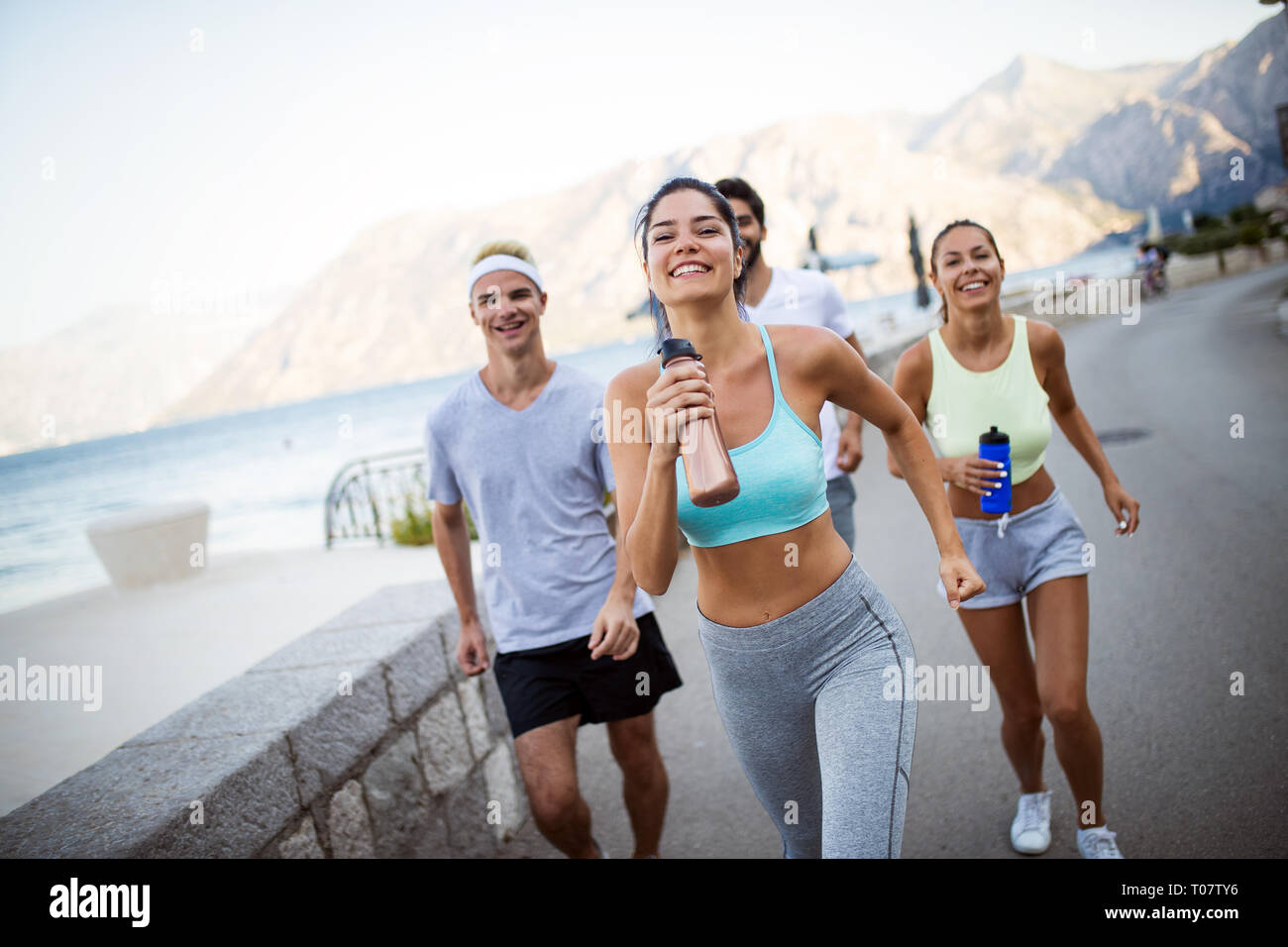 Group of young people friends running outdoors at seaside Stock Photo ...