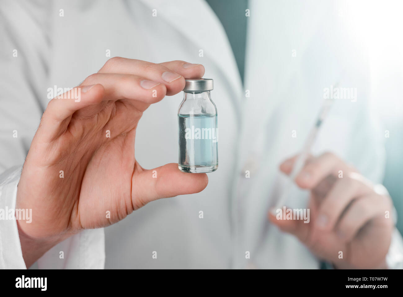 Injection vial of blue liquid Stock Photo - Alamy