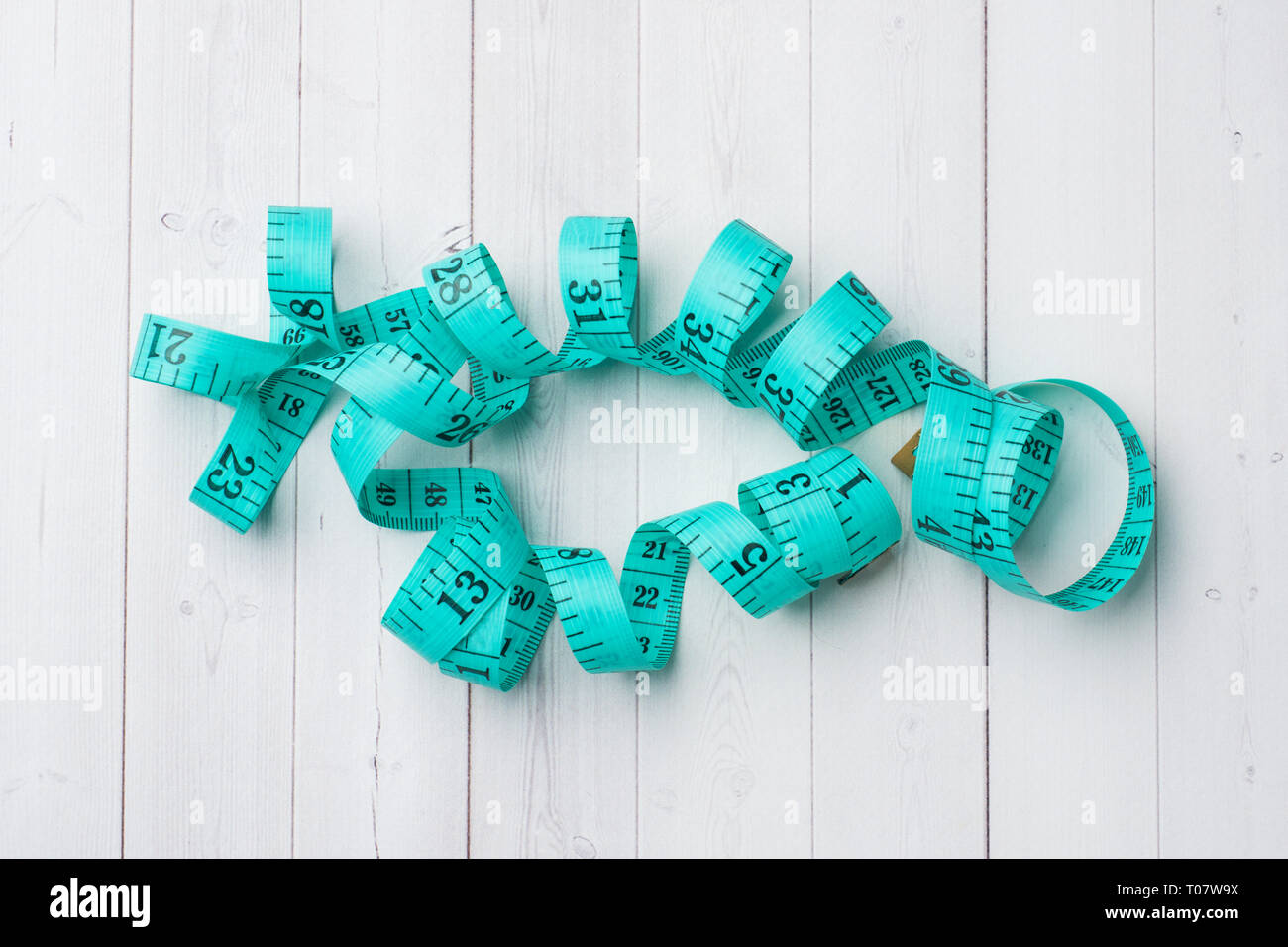 Rolled centimeter ruler with measuring compartments on white background ...