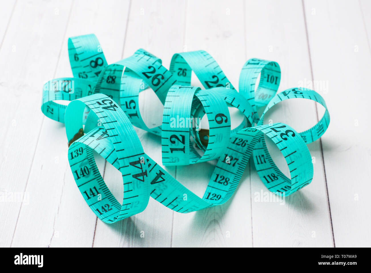 Rolled centimeter ruler with measuring compartments on white background ...