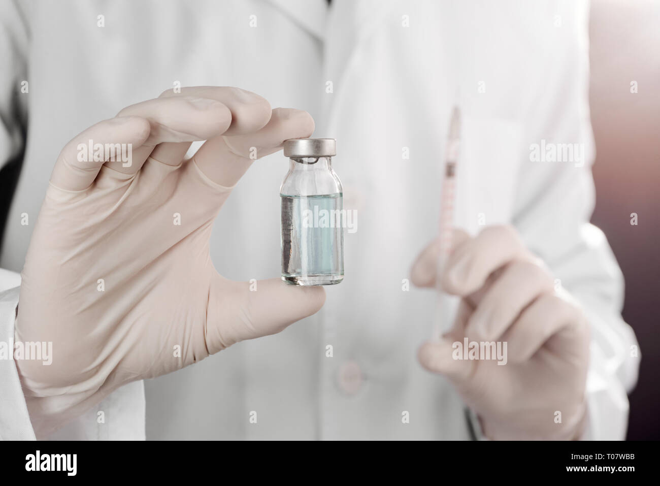 Doctor holding a vial Stock Photo - Alamy