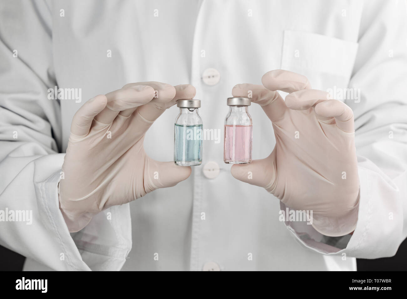 Doctor holding two vials Stock Photo - Alamy