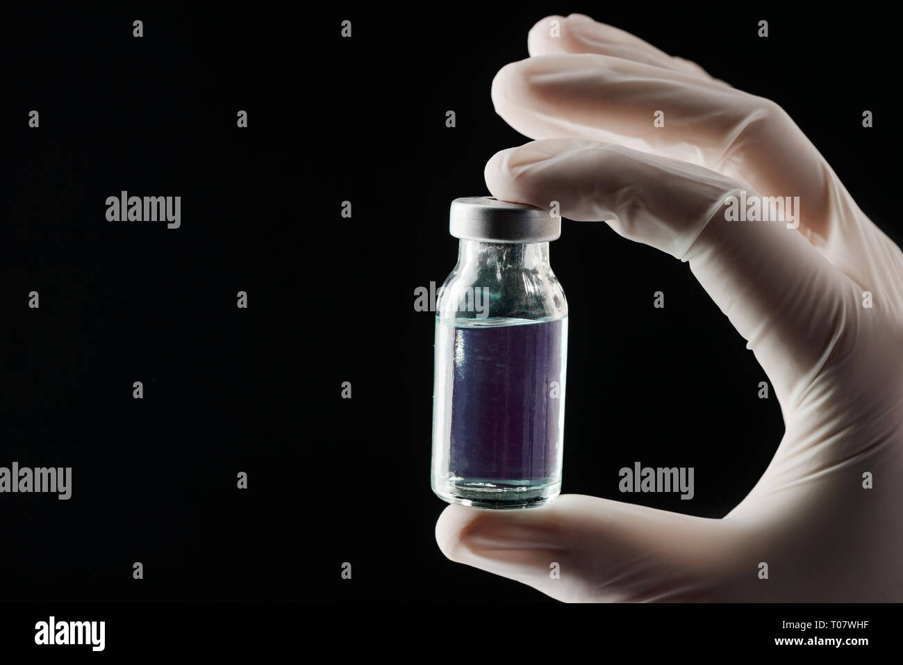 Scientist holding a vial Stock Photo - Alamy