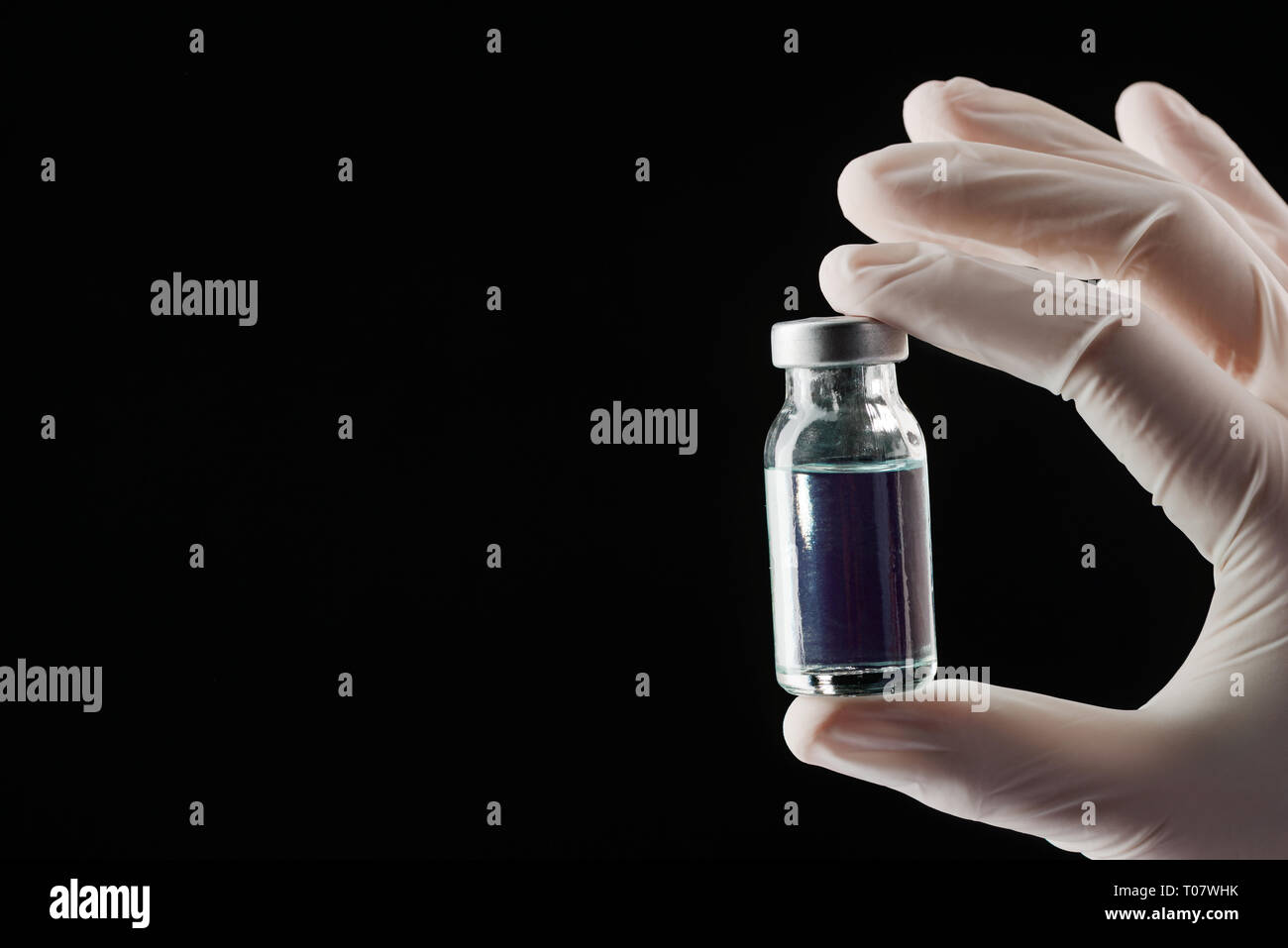 Vaccine vial with needle and syringe on black background hi-res stock ...