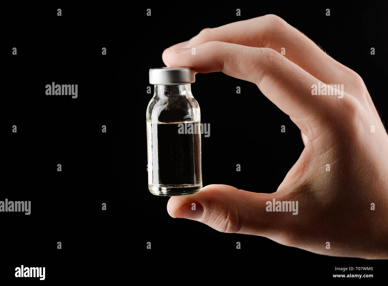 Vial of medication on black Stock Photo - Alamy
