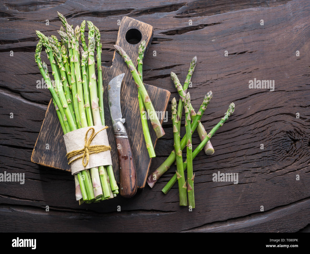 Green young asparagus sprouts on wooden table. Top view Stock Photo - Alamy