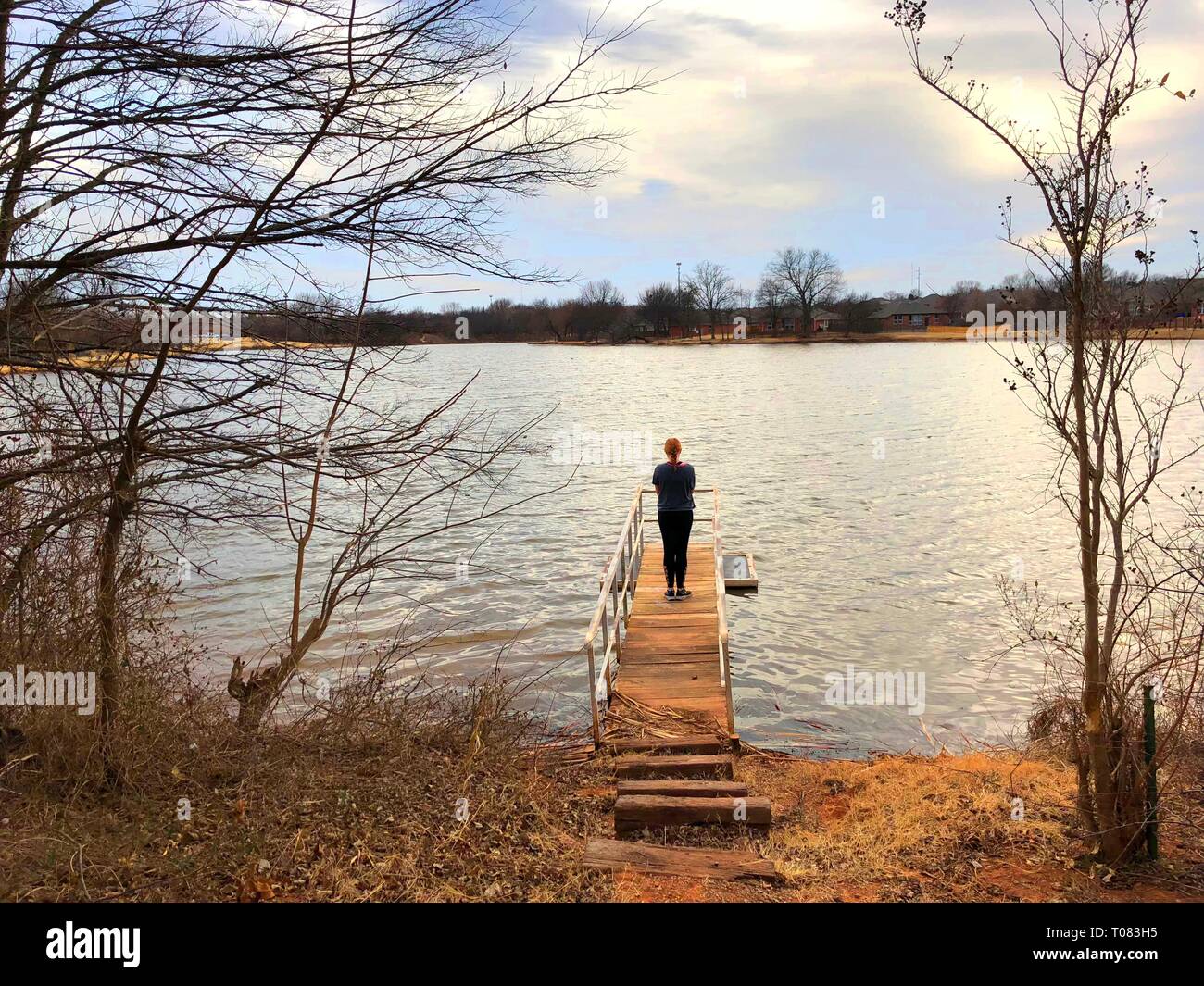 NORMAN, OKLAHOMA—FEBRUARY 2018: A woman stands on a floating dock ...