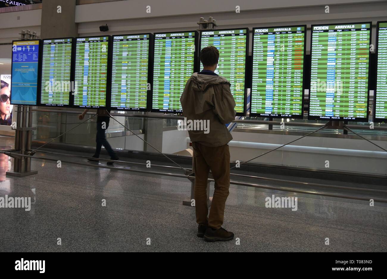 DENVER, COLORADO—MARCH 2018: A passengers checks the digital flight ...