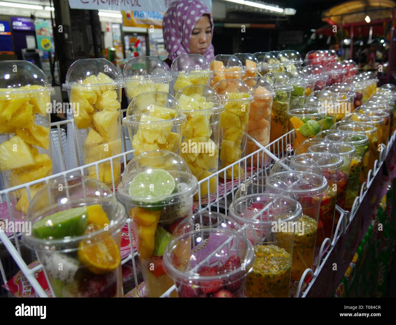 CHIANG MAI, THAILAND—MARCH 2018: A woman stands behind her rows of ...