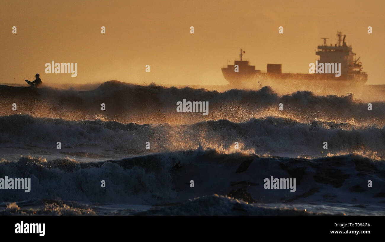 A cargo ship rocks about in rough seas in the North Sea off the coast ...