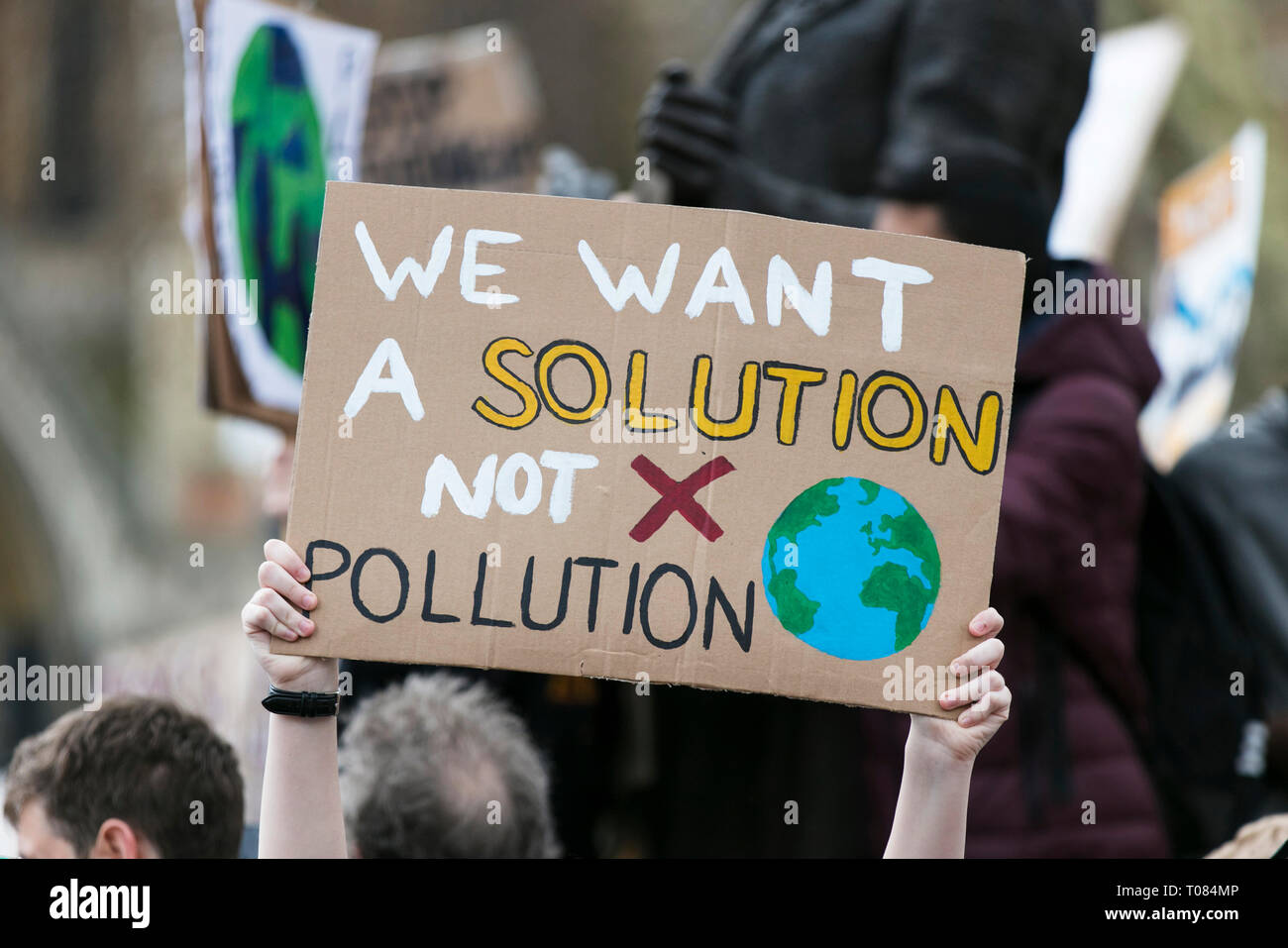 People with banners protest as part of a climate change march Stock ...