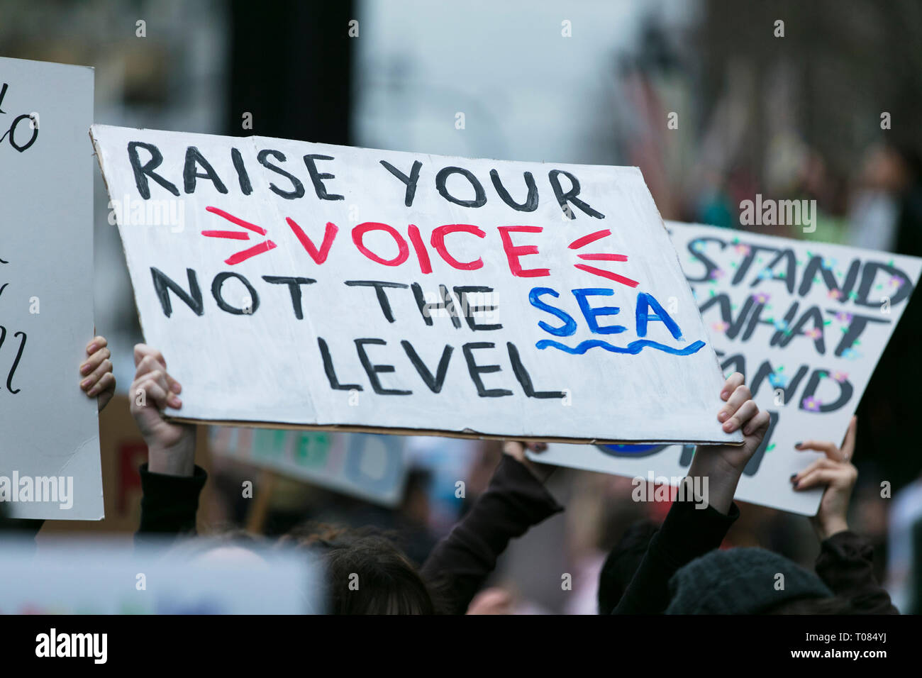 People with banners protest as part of a climate change march Stock ...