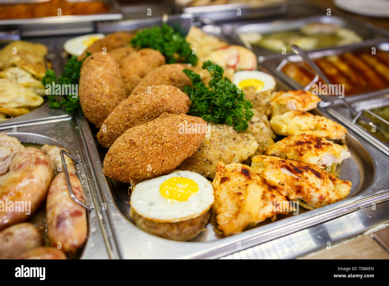 A set of meat dishes in the trays, a banquet table Stock Photo - Alamy
